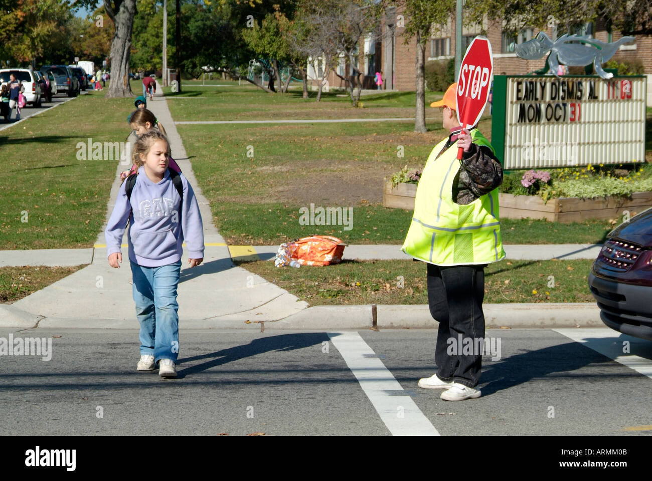 Elementary school crossing guard provides safety to children crossing ...