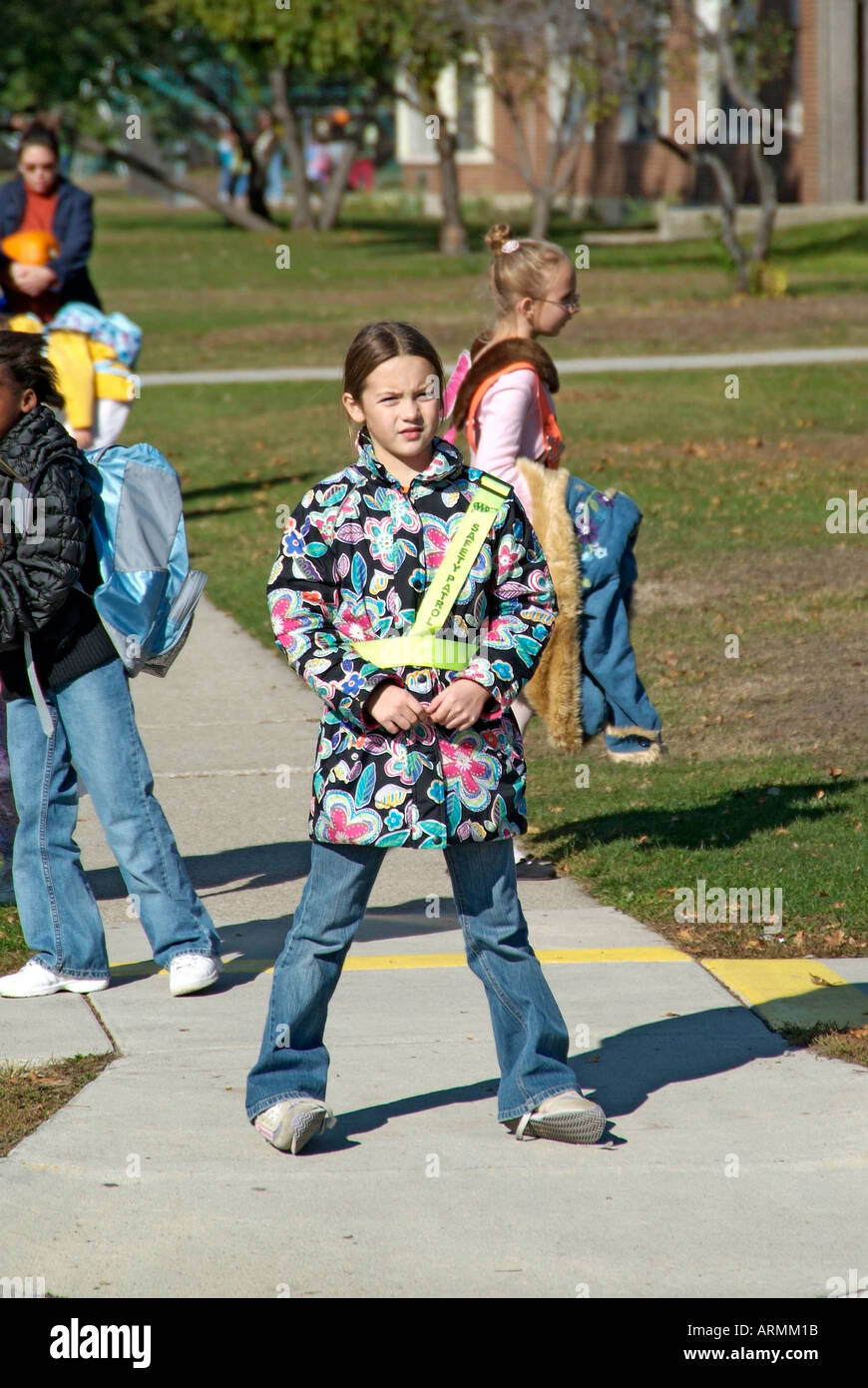 Elementary school crossing guard provides safety to children crossing ...
