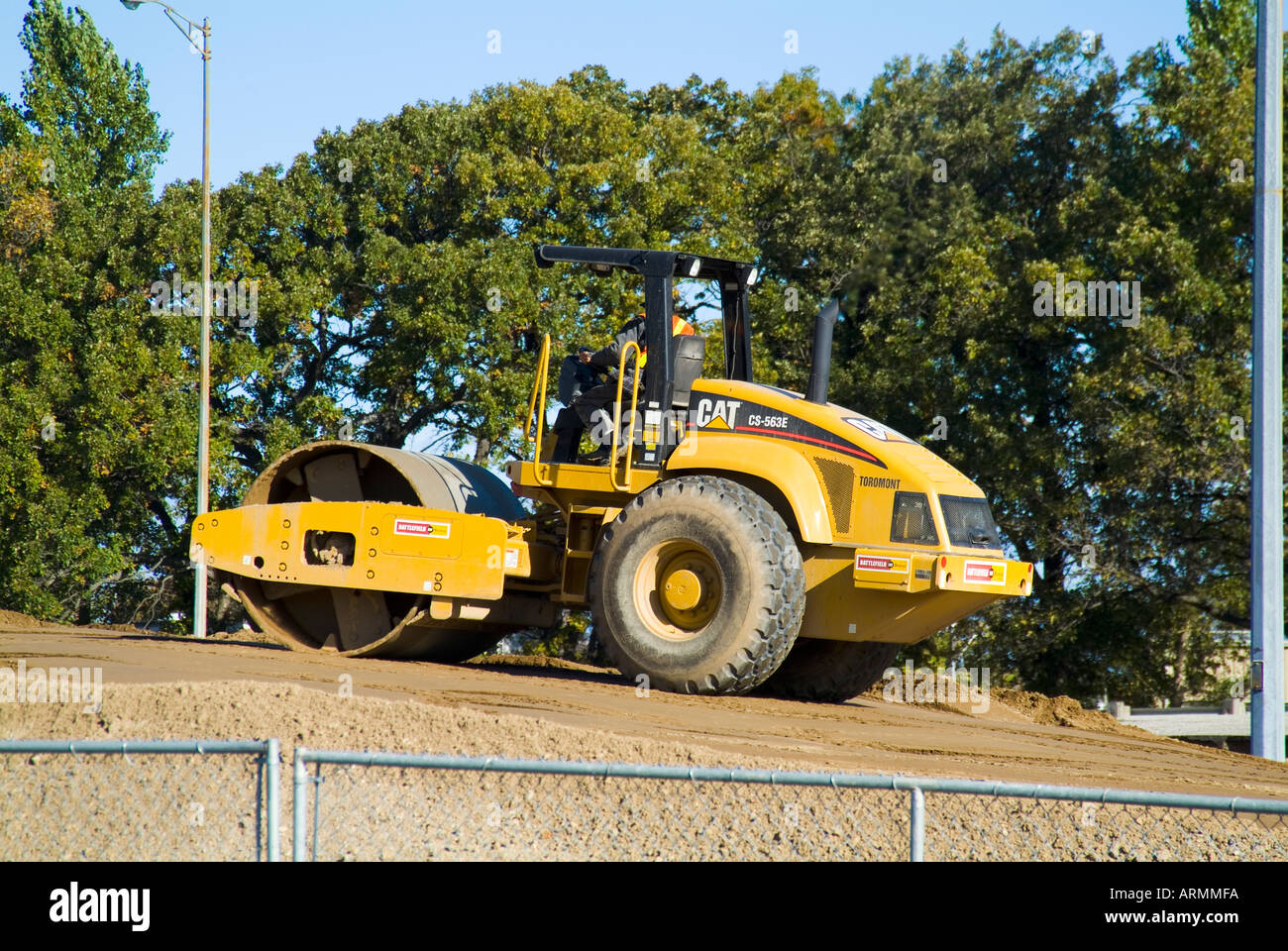 Heavy road construction building equipment work as a team to build a ...
