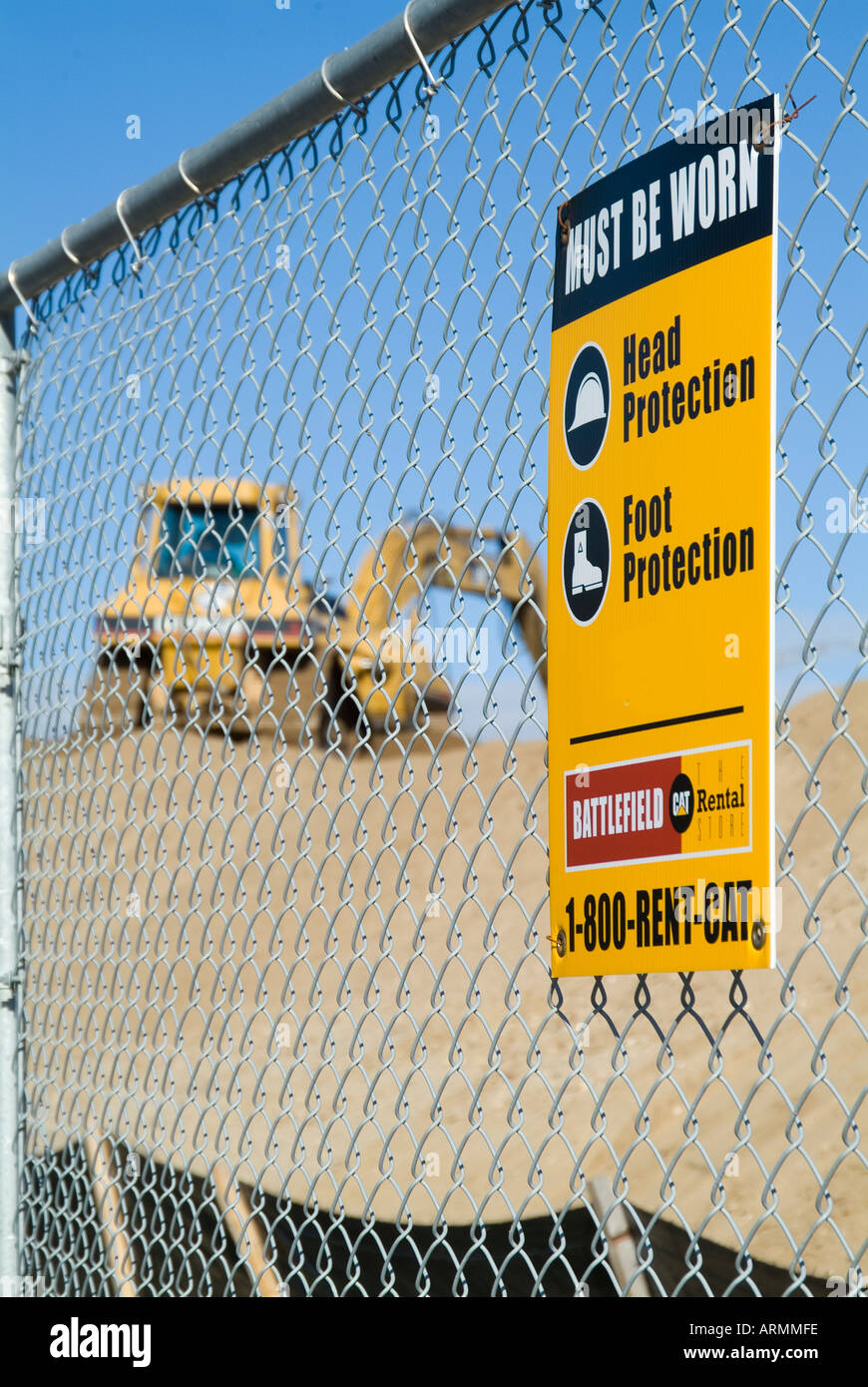 Sign at construction sight warns workers and others that head and foot ...