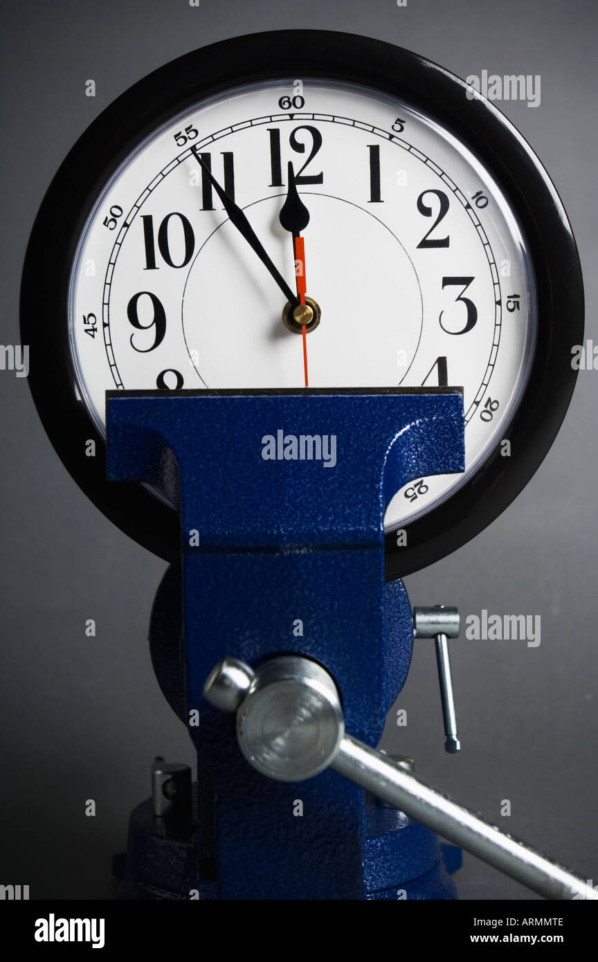 Clock in vice grips Stock Photo - Alamy