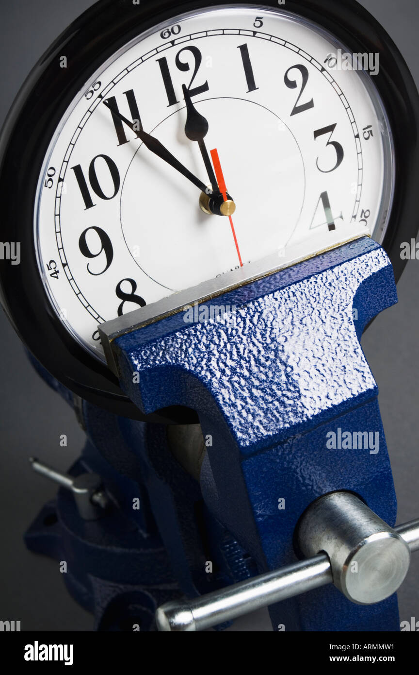 Clock in vice grips Stock Photo - Alamy