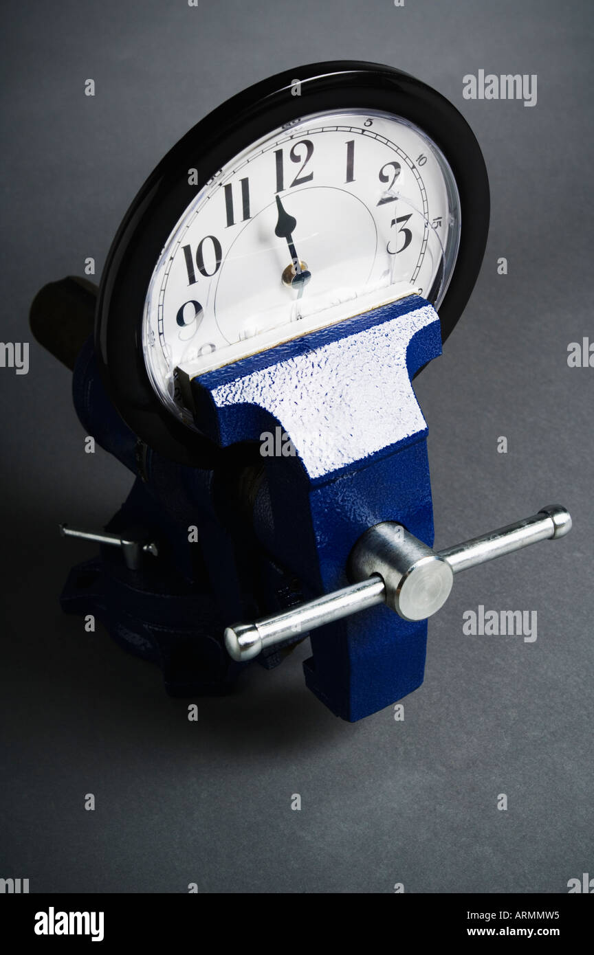 Clock in vice grips Stock Photo - Alamy