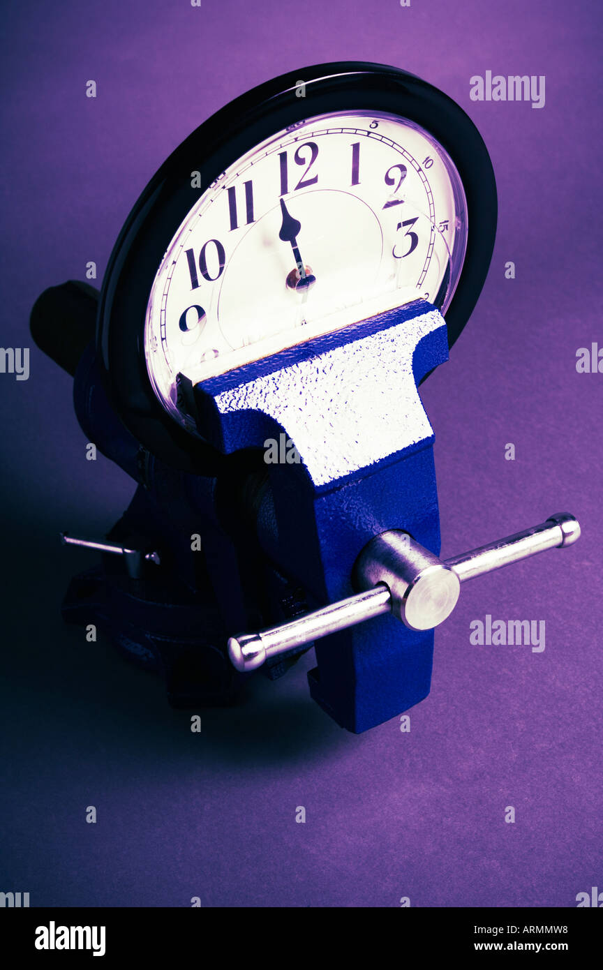 Clock in vice grips Stock Photo - Alamy
