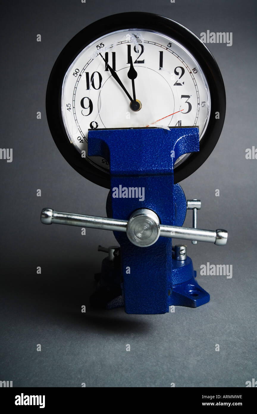 Clock in vice grips Stock Photo - Alamy