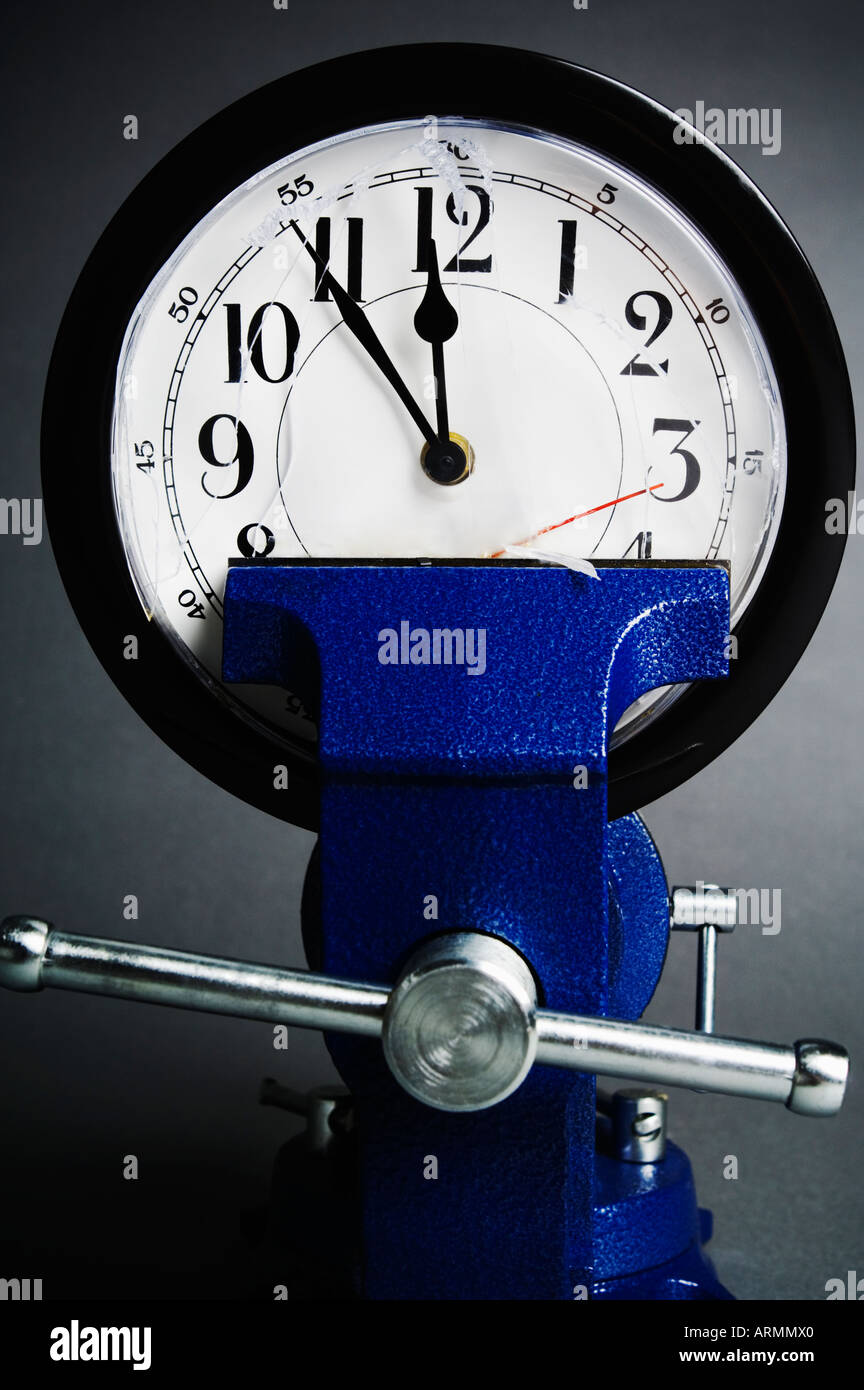 Clock in vice grips Stock Photo - Alamy