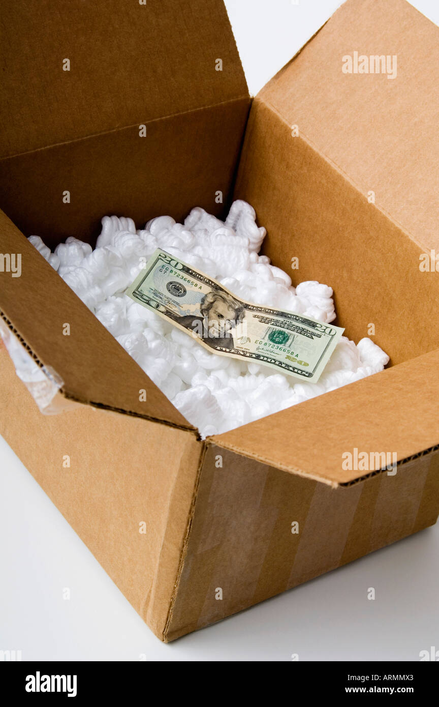Cardboard box with packaging and money Stock Photo - Alamy