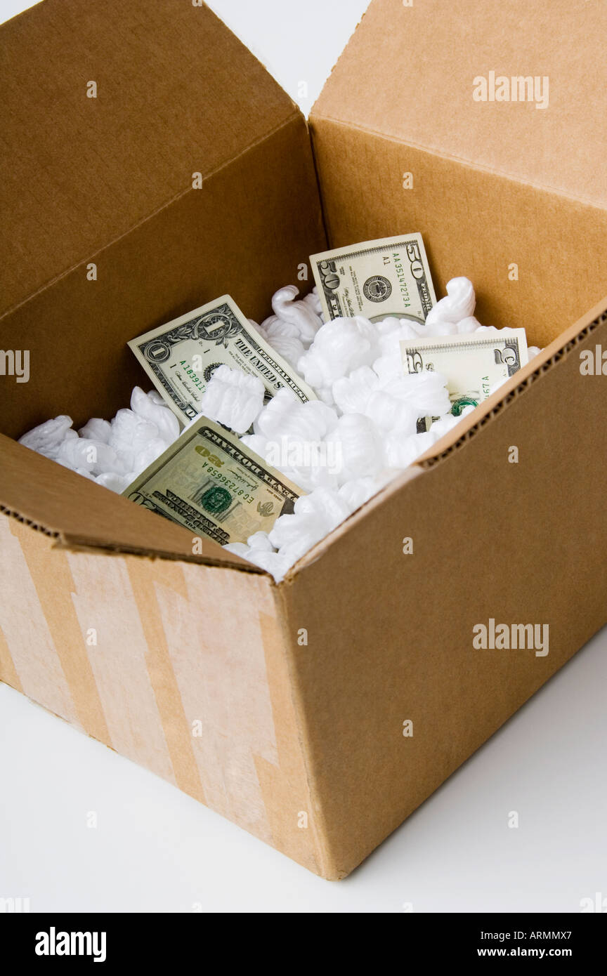 Cardboard box with packaging and money Stock Photo - Alamy
