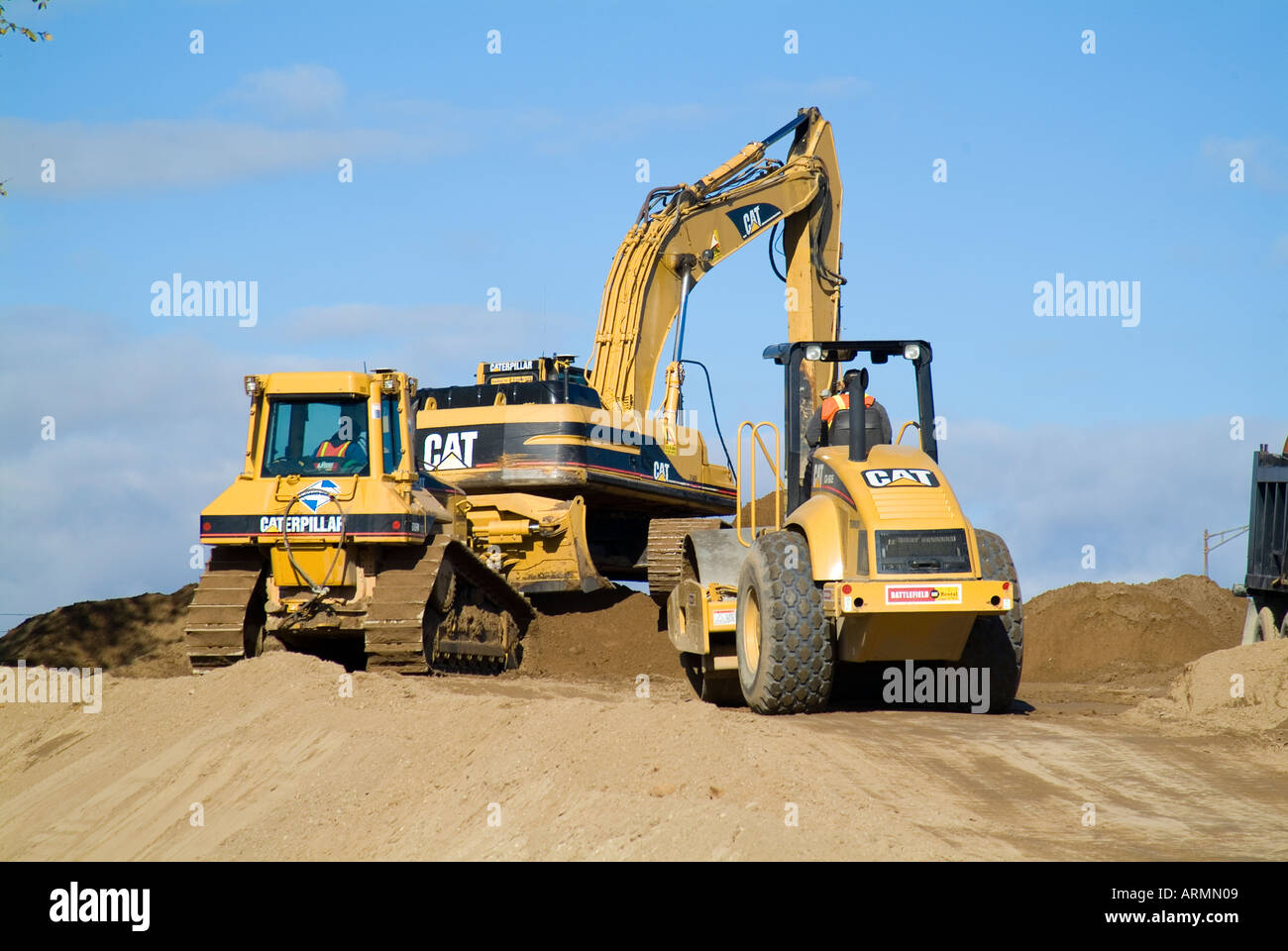 Heavy road construction building equipment work as a team to build a ...