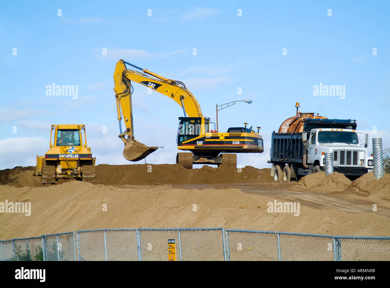 Heavy road construction building equipment work as a team to build a ...