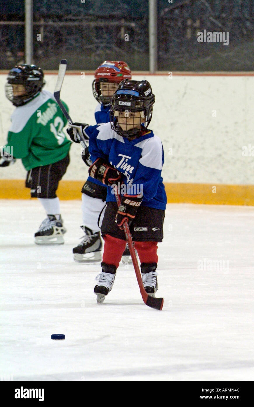 5 year old boys learn how to play the game of ice hockey Stock Photo ...
