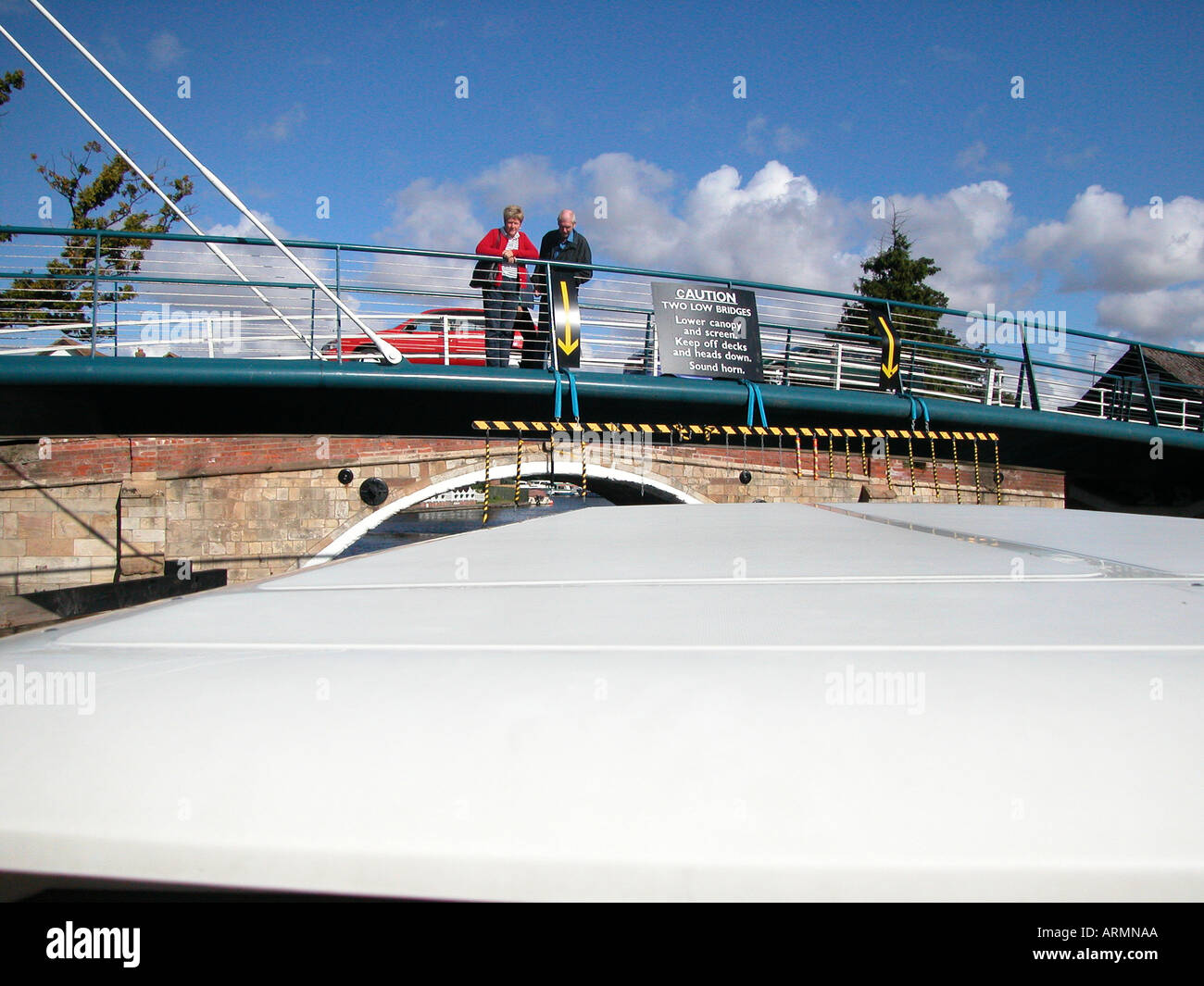 Broads cruiser negotiating a low bridge at Wroxham in Norfolk, Broads ...