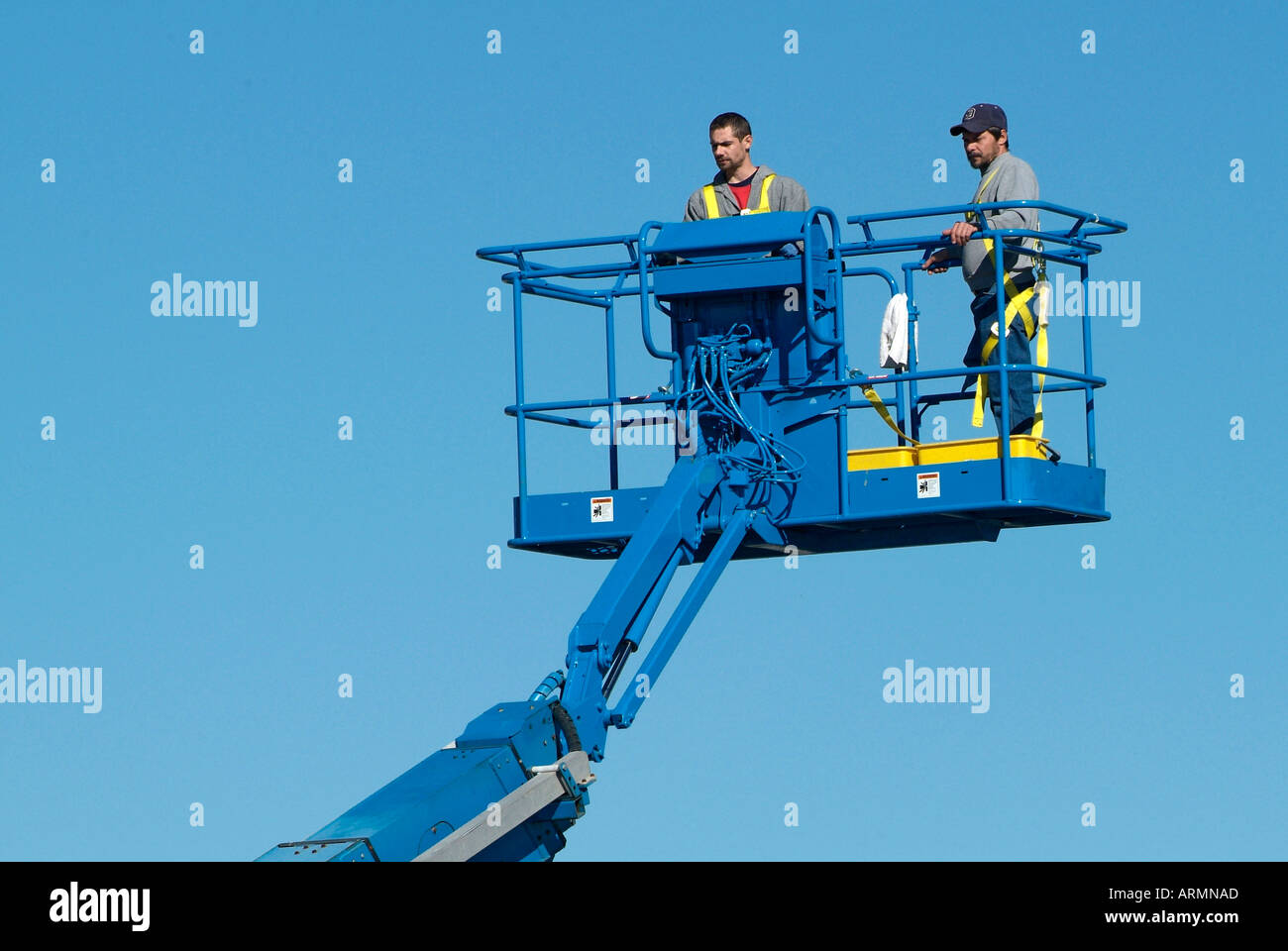 Window washers use mechanical industrial boom to elevate them against ...