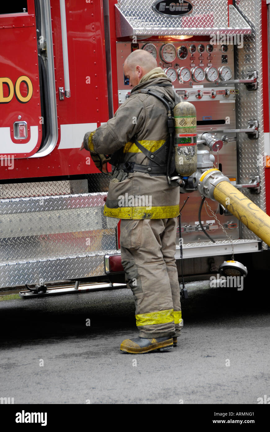 Fireman with fire fighting equipment respond to emergency fire ...