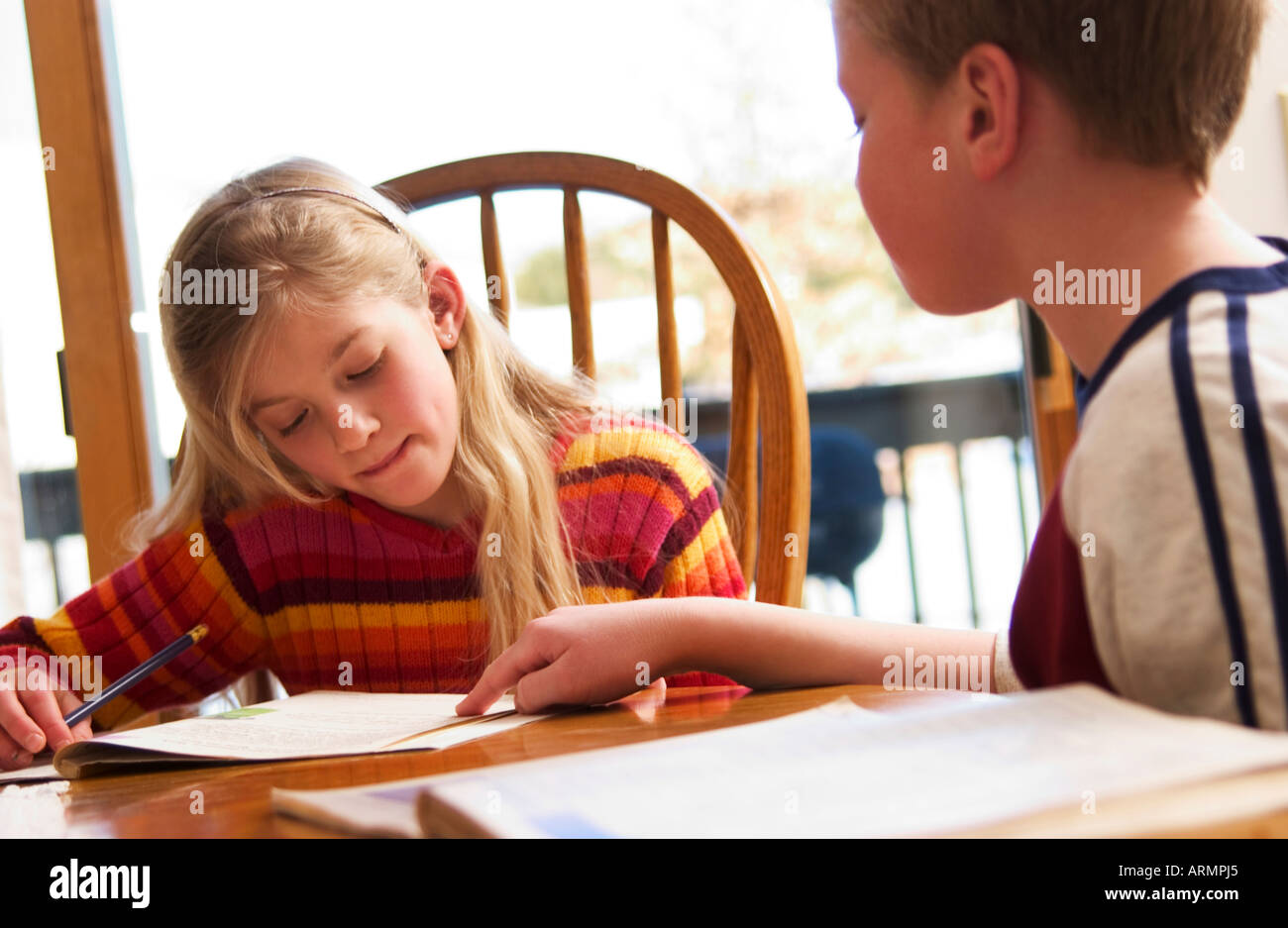 Kids doing homework Stock Photo - Alamy