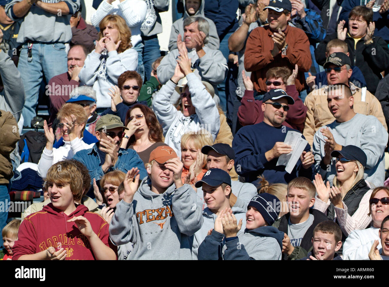 Crowd of people friends and family cheer and support a high school ...