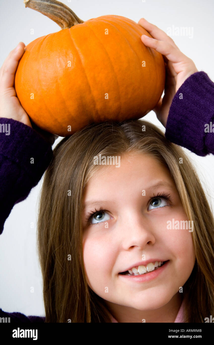 Girl with pumpkin on her head Stock Photo - Alamy
