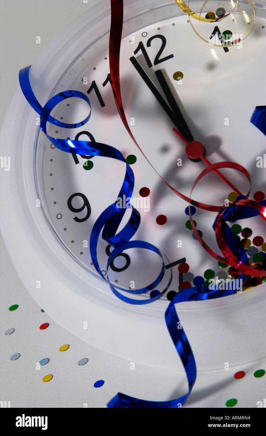 Clock turning midnight Stock Photo - Alamy