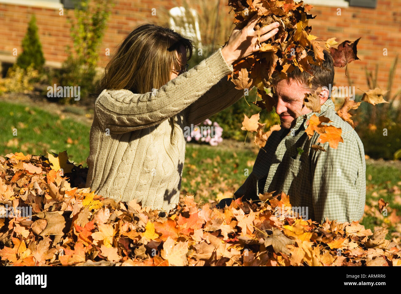 Couple playing in fall leaves Stock Photo - Alamy