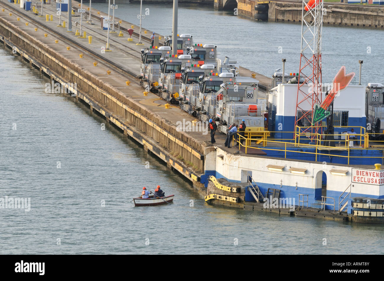 Two men in a rowboat have the job of throwing guide lines to vessels ...