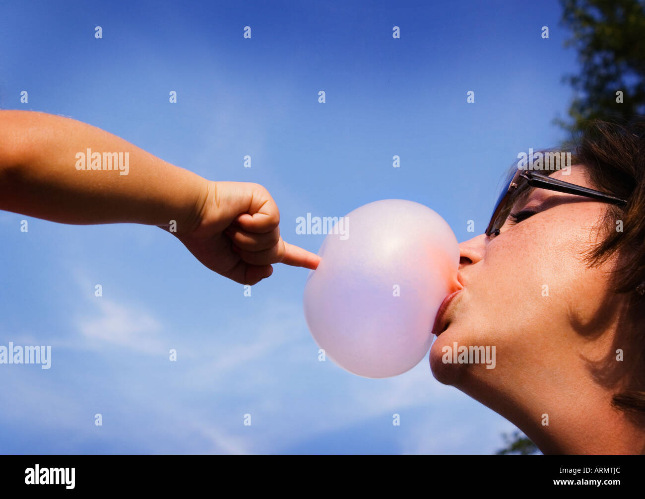 Child popping bubble Stock Photo - Alamy