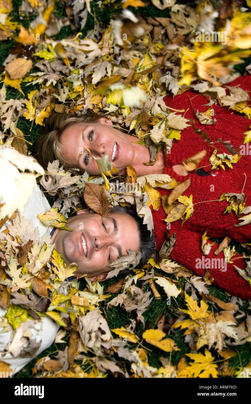 Couple in fall leaves Stock Photo - Alamy
