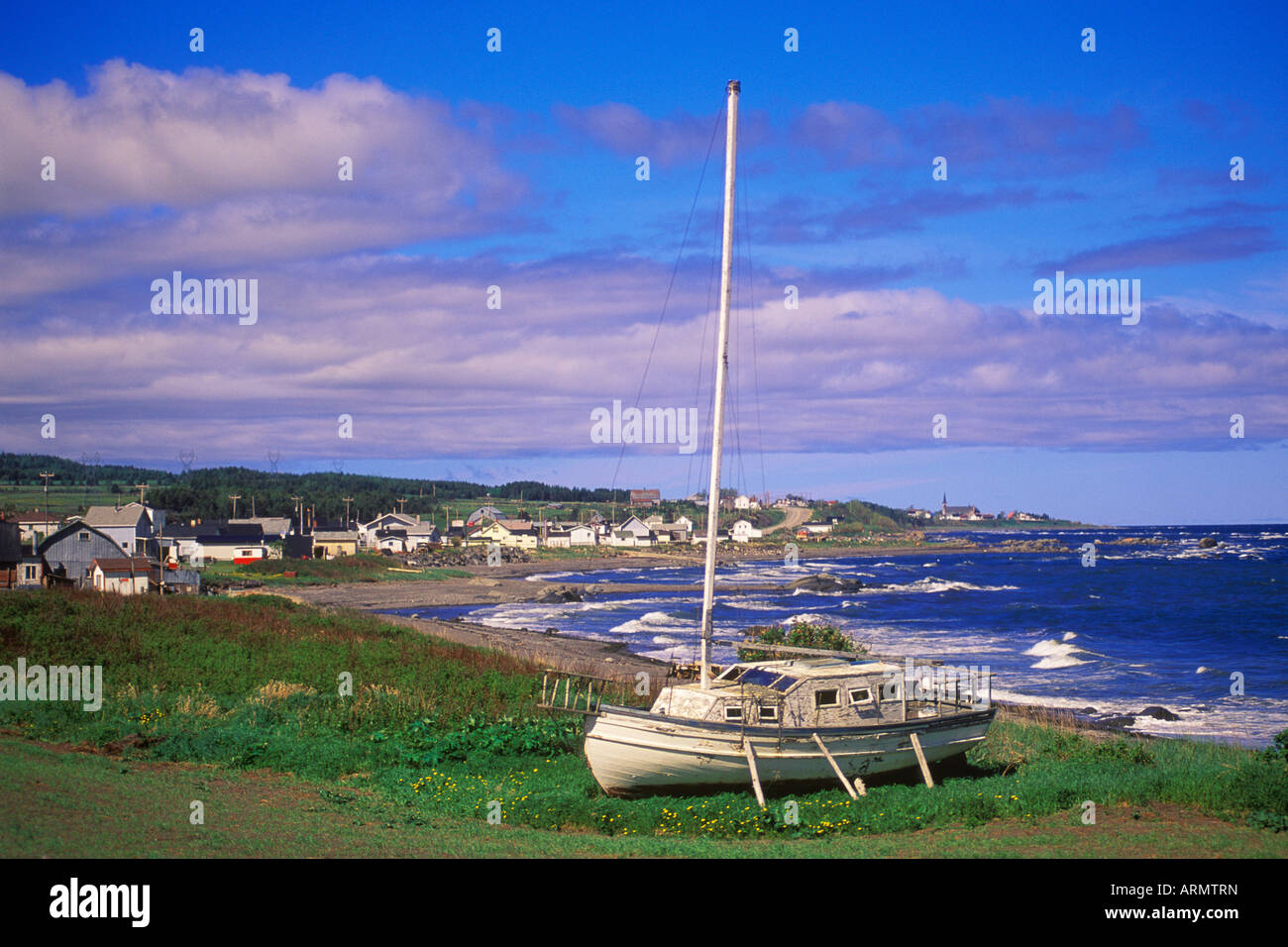 North shore of Gaspe Peninsula on St. Lawrence River, derelict sailboat ...