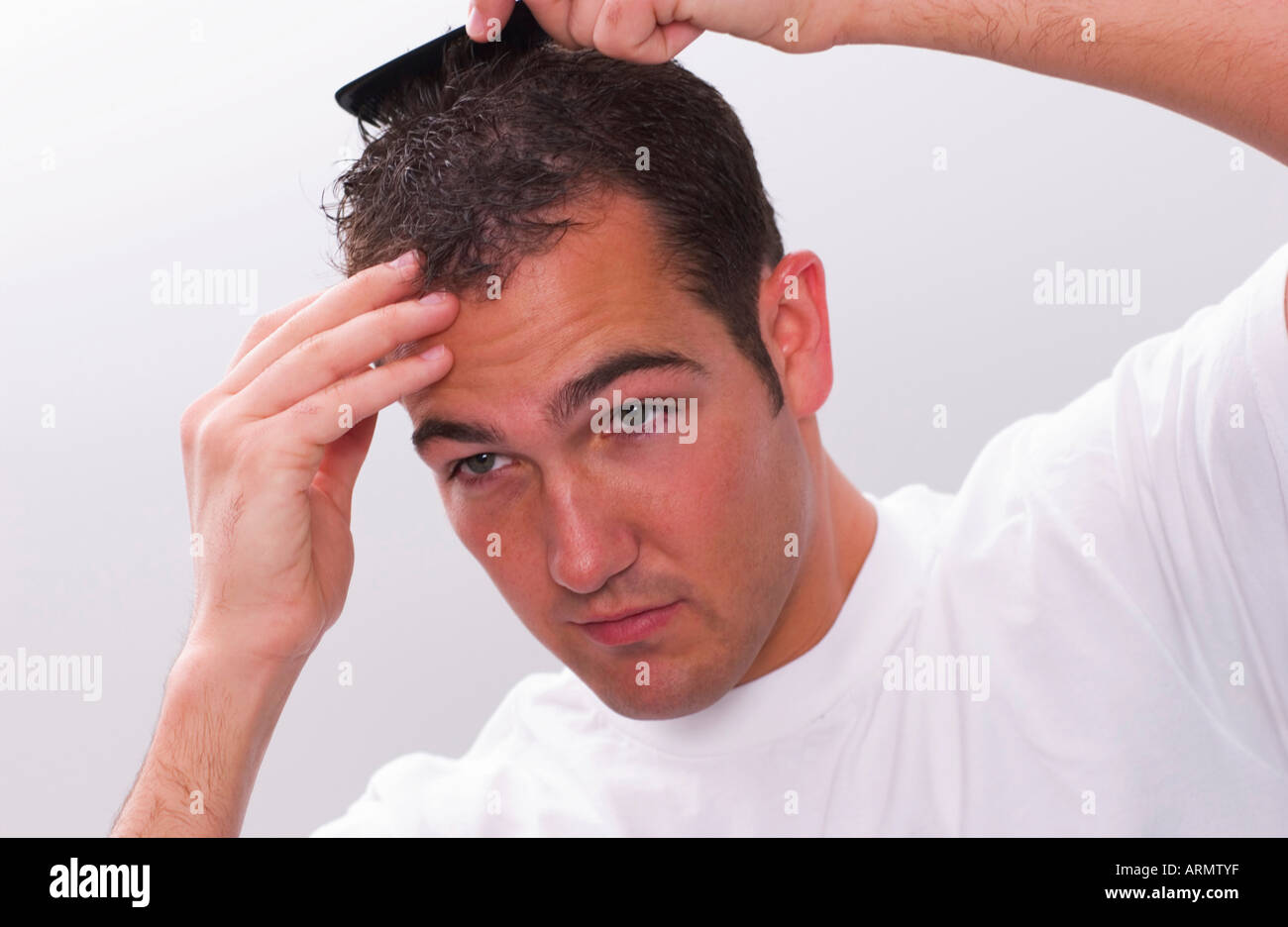 Man combing his hair Stock Photo - Alamy