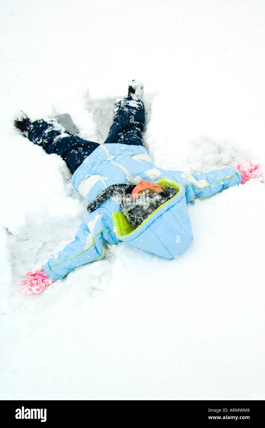 Girl making angel in snow hi-res stock photography and images - Alamy