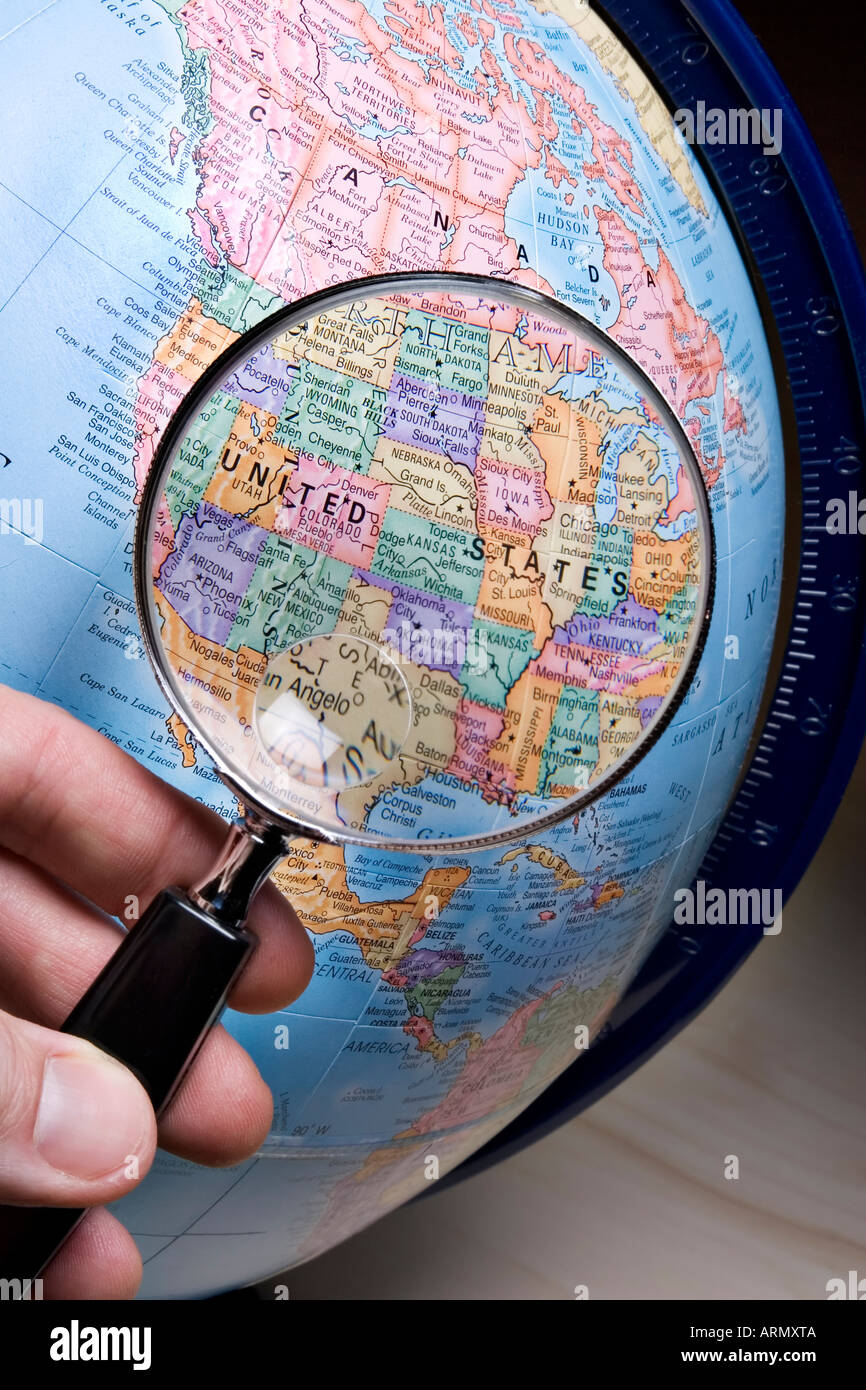 Globe and magnifying glass Stock Photo - Alamy