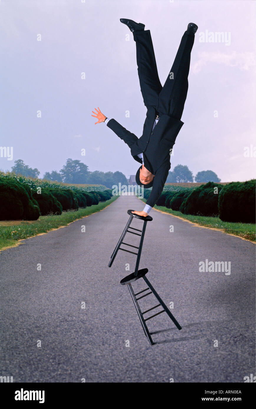 Balancing business man Stock Photo - Alamy