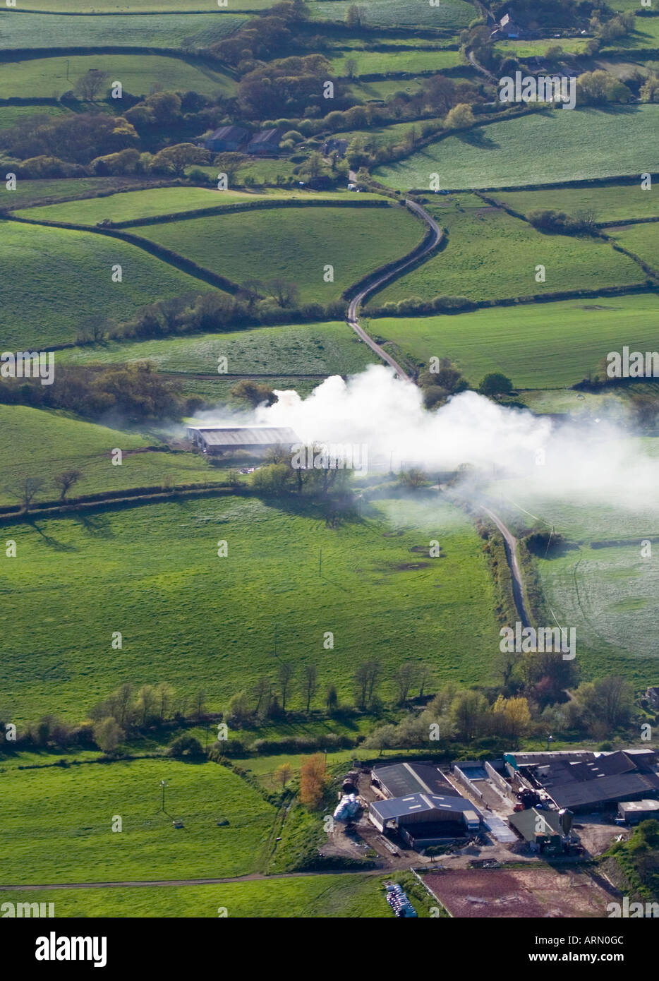 Aerial view of farm buildings on fire. Billowing smoke. Air pollution ...