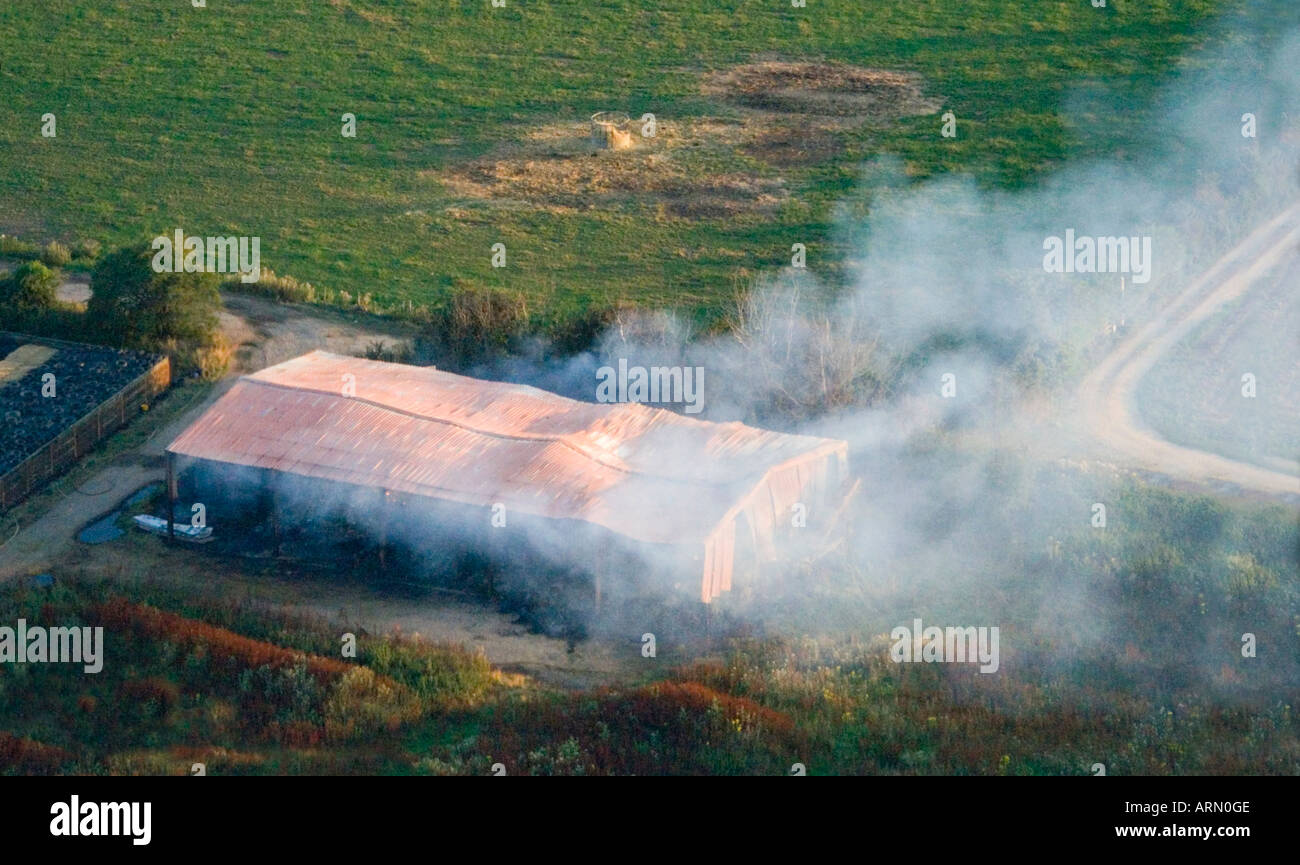 Aerial view of a barn on fire. Billowing smoke. Air pollution. Roof ...