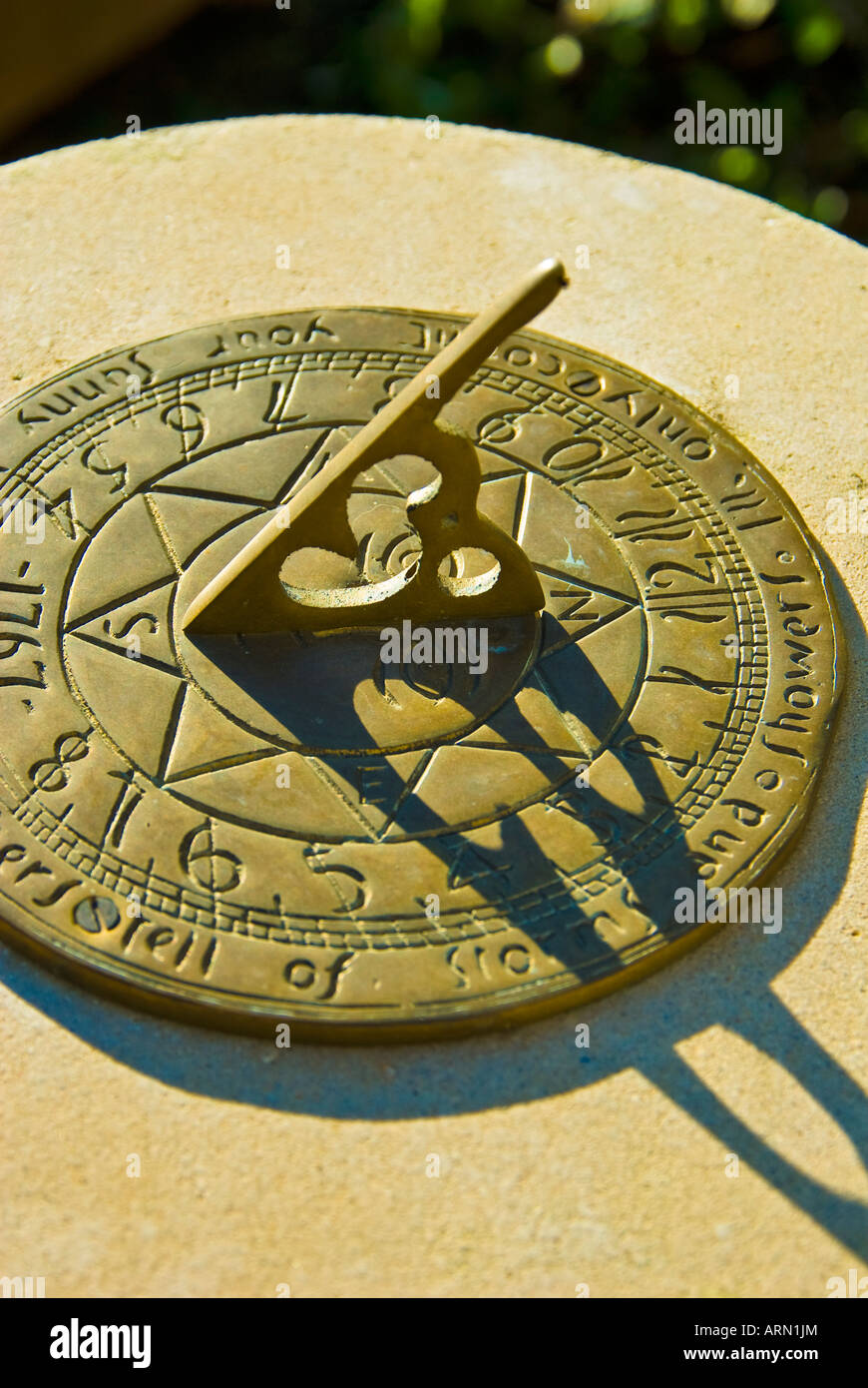 Brass sundial in a garden Stock Photo - Alamy