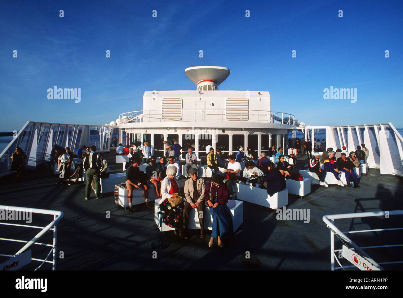 Passengers on the deck of a BC Ferry Spirit Class vessel between ...