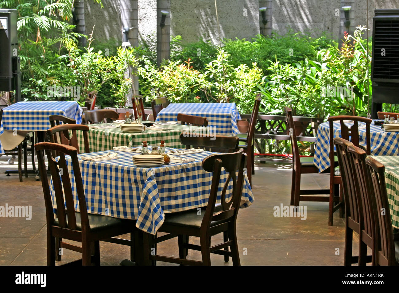 Outdoor italian restaurant with chairs and tables with checked ...