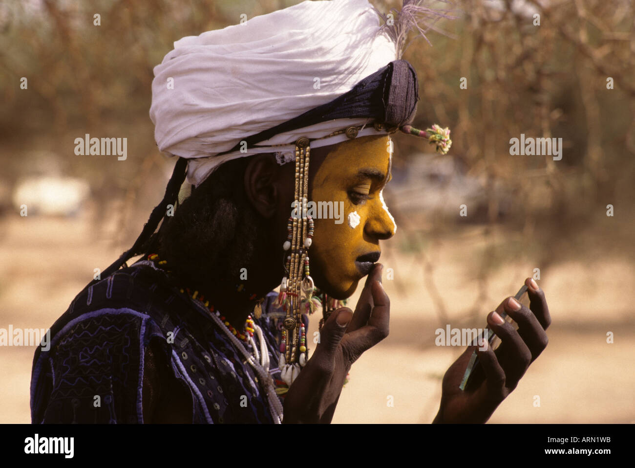 Akadaney, Niger, Africa. Fulani Wodaabe Dancer Checking Appearance in a ...