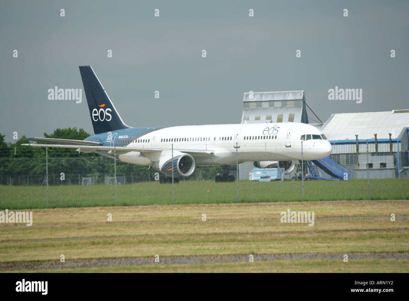 An EOS Airlines passenger aircraft shimmers in the heat, parked in a ...