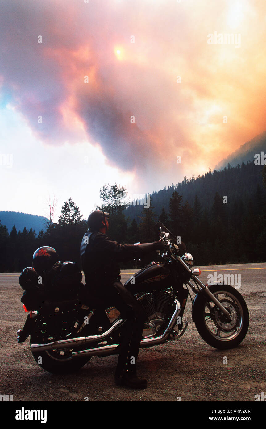 Forest fire, biker at roadside, West Kootenays near Cranbrook, British ...