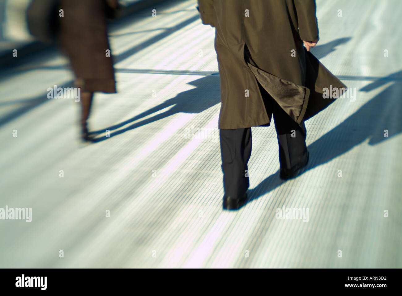 partial view of man and woman walking separately Stock Photo - Alamy