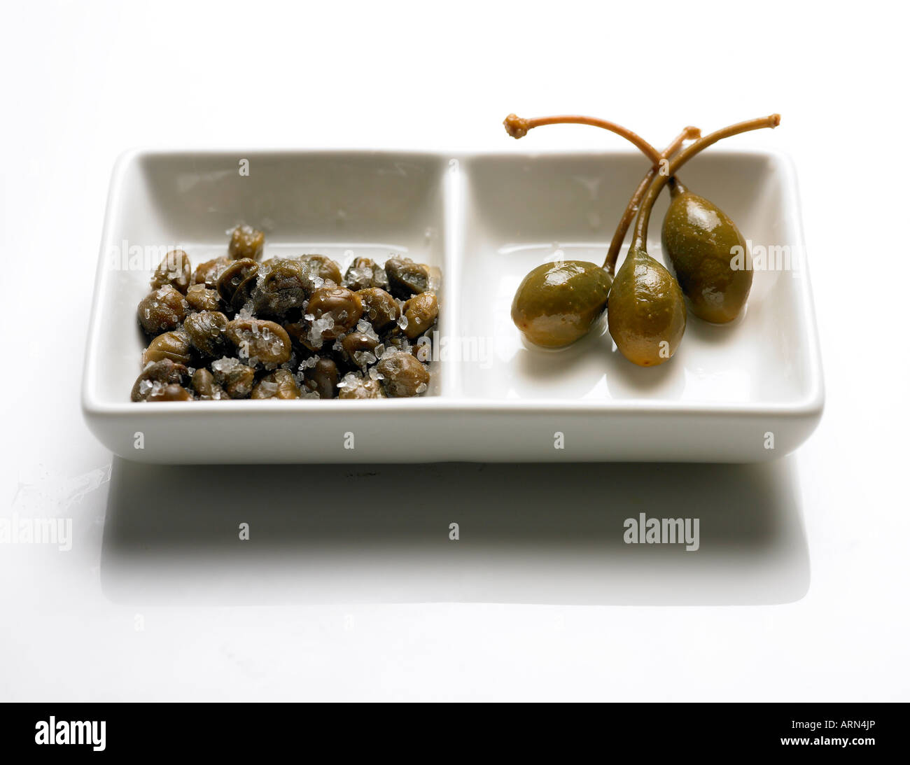 caper berries and salted capers from plant Capparis spinosa Stock Photo ...