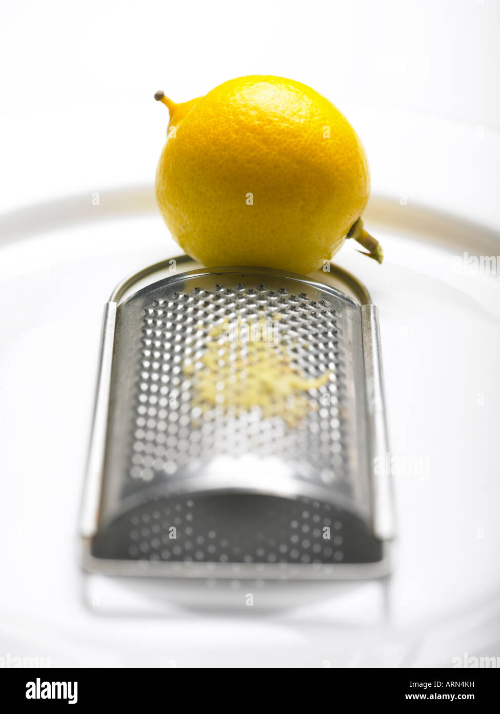 lemon being grated on lemon zester Stock Photo - Alamy