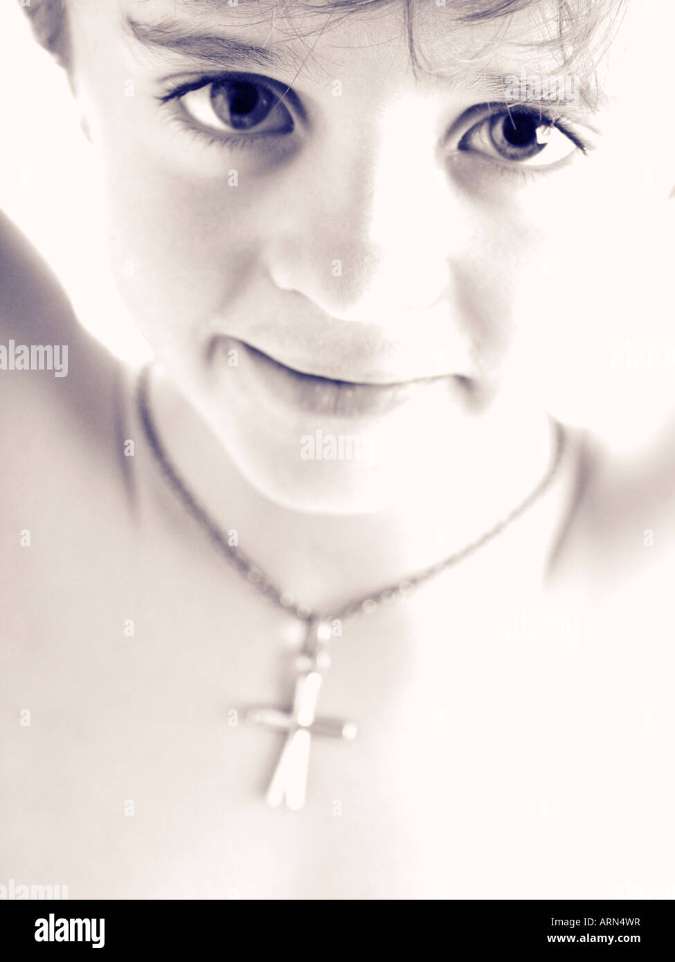 boy wearing chain with cross hanging on it Stock Photo - Alamy