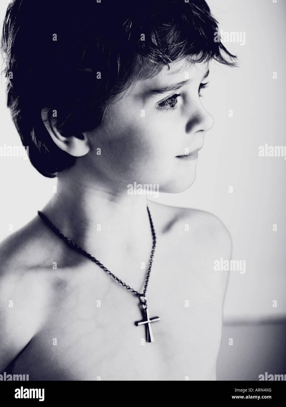 boy wearing chain with cross hanging on it Stock Photo - Alamy