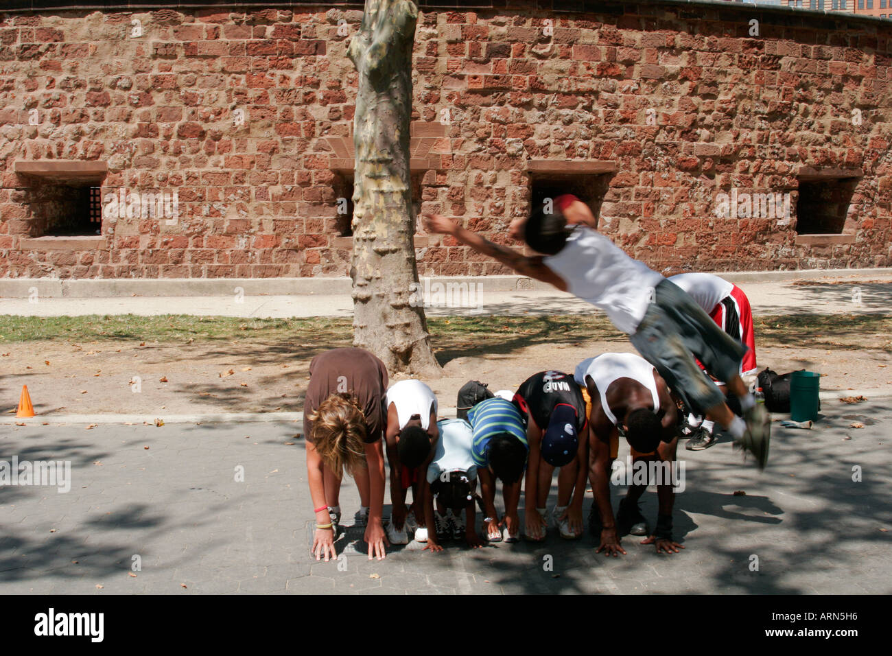 Children jumping in air in park hi-res stock photography and images - Alamy