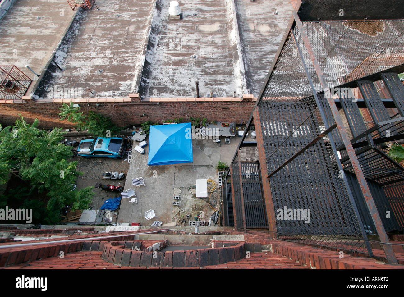 Aerial view of a Brooklyn apartment courtyard with canopy tent, parked ...