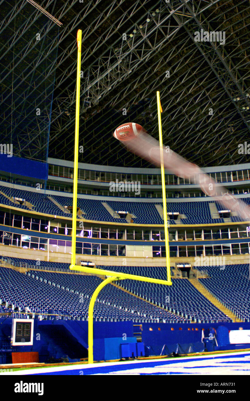 Football kicked through upright goal post at stadium Stock Photo - Alamy