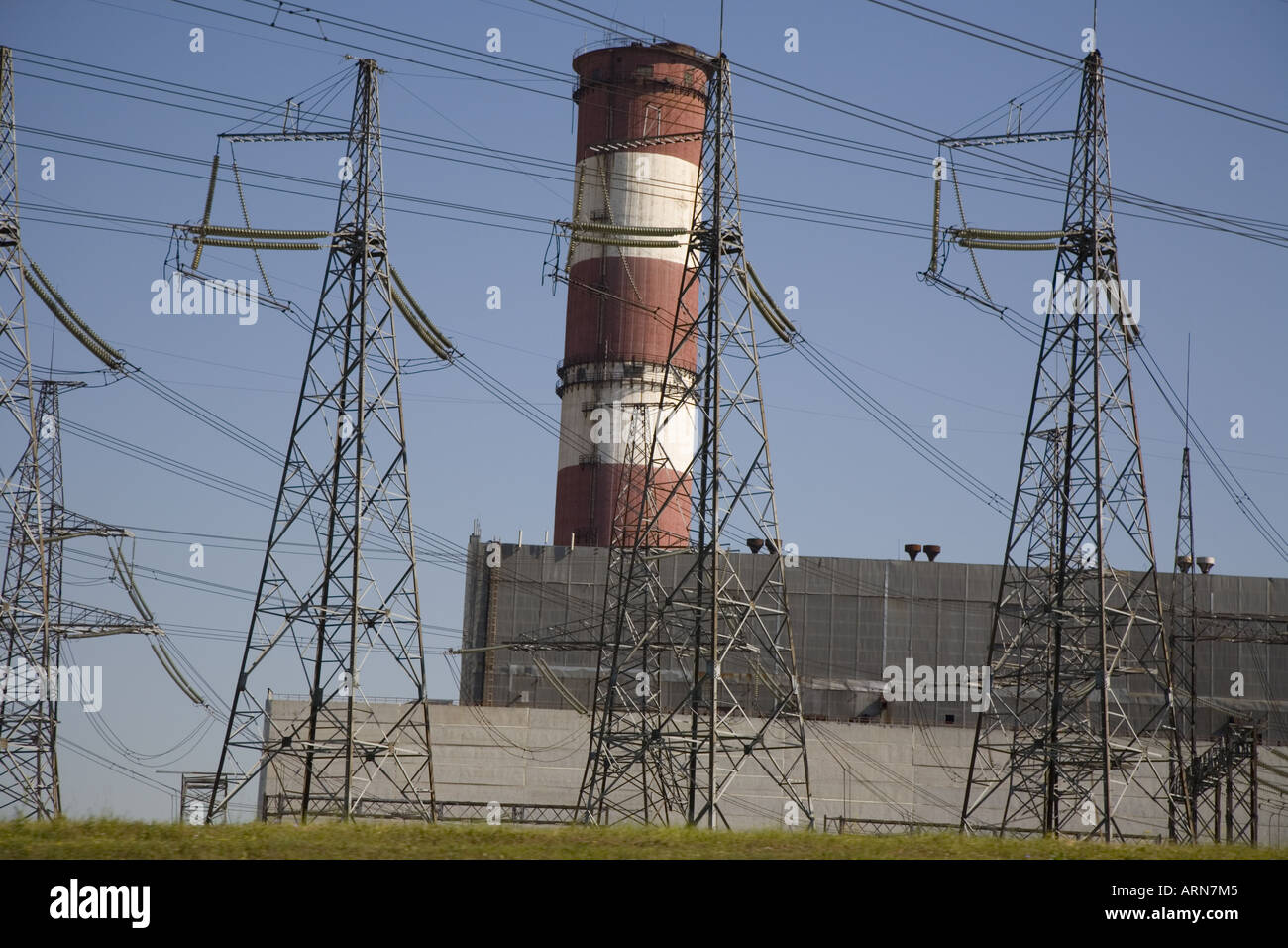 Red and white painted chimney and electricity lines and pylons Moscow ...