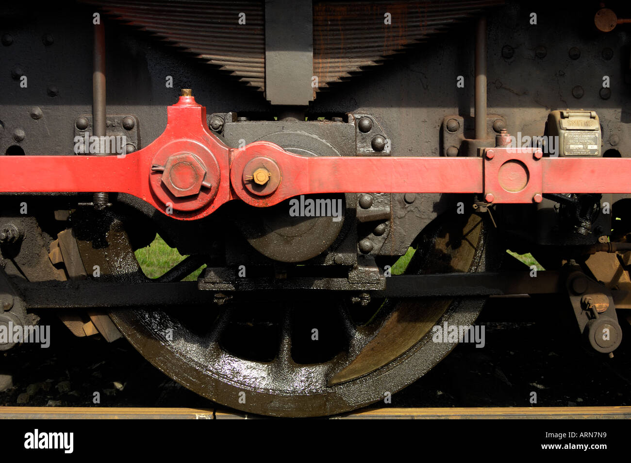 Steam engine detail side view of big metal wheel Stock Photo - Alamy