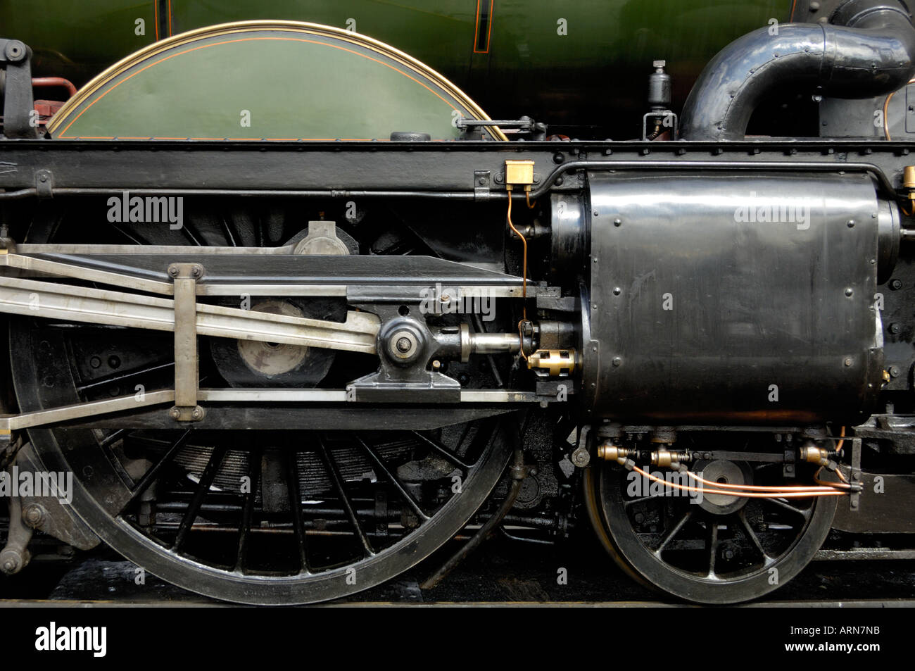 Steam engine detail side view of big metal wheel Stock Photo - Alamy